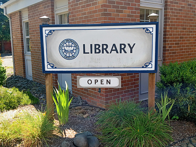 The Brownsville Library sign promises adventures that require no passport, just a library card and an afternoon to spare.