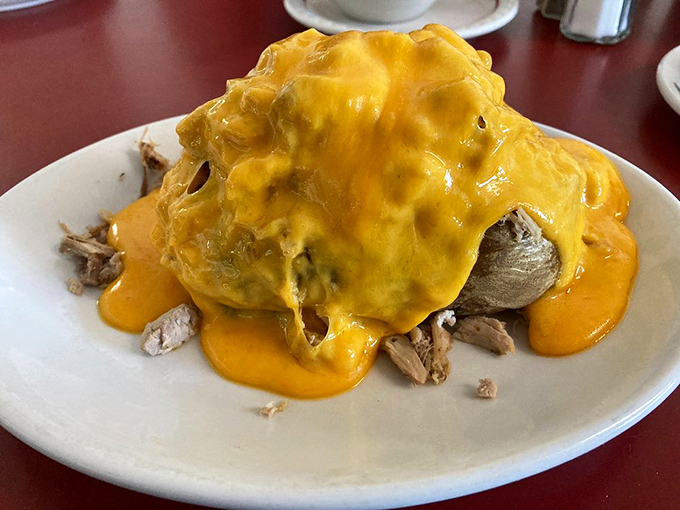 This loaded potato isn't just a side&mdash;it's a main event draped in melted cheese that flows like a yellow lava flow of deliciousness.