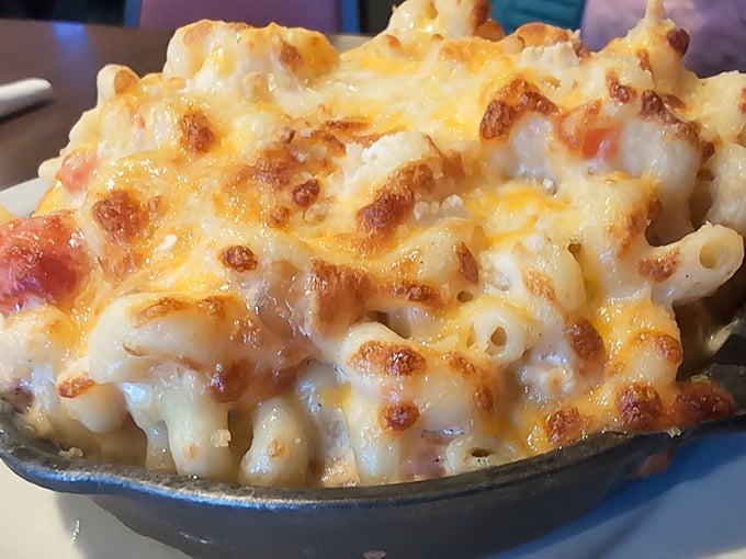 Mac and cheese that would make your grandmother both jealous and proud. That golden crust hides a creamy treasure beneath&mdash;comfort in a cast iron dish. 