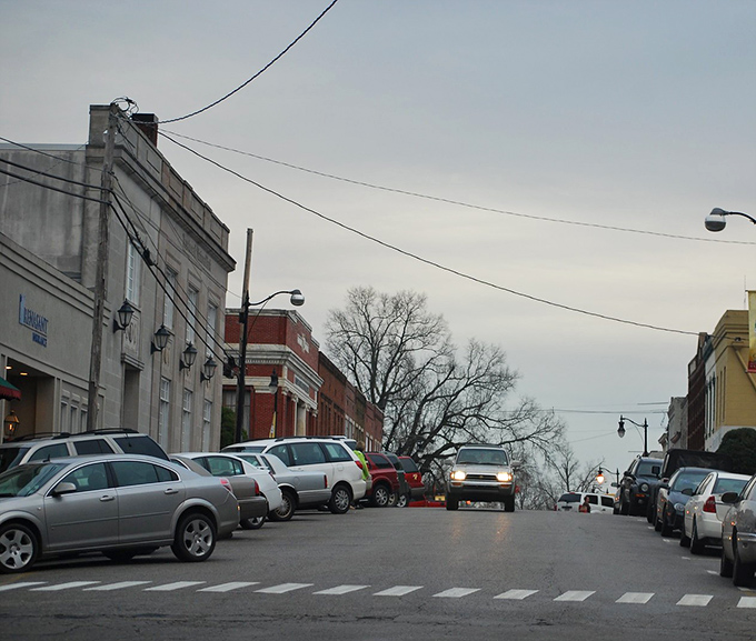Downtown Corinth at dusk, when parallel parking becomes performance art and the golden hour lights up historic facades like a Hollywood set.