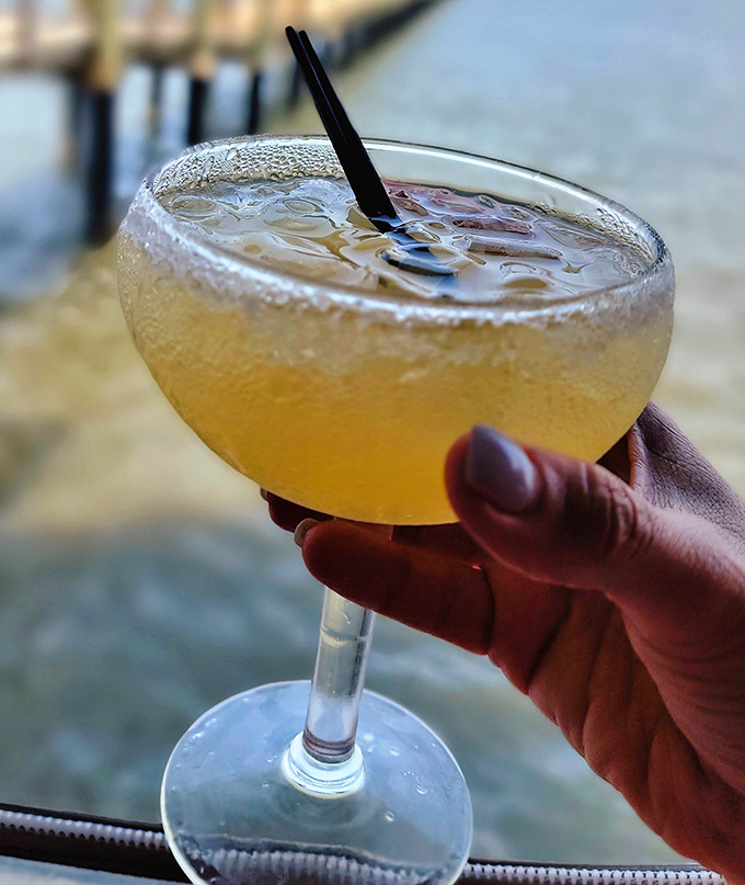 Sunshine in a glass! This tropical concoction, beaded with condensation, promises a vacation state of mind with every sip – waterfront view included.
