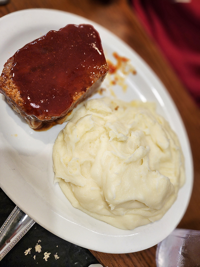 Meatloaf and mashed potatoes—the Fred Astaire and Ginger Rogers of comfort food, dancing together in perfect harmony on a simple white plate.
