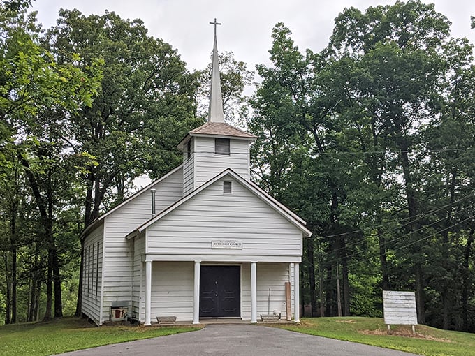This charming white chapel stands as a peaceful sanctuary among the trees, where Sunday services come with a side of birdsong.