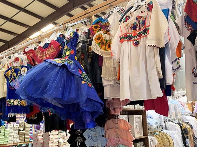 A rainbow of embroidered fabrics tells cultural stories through thread and color, each garment more vibrant than the last.