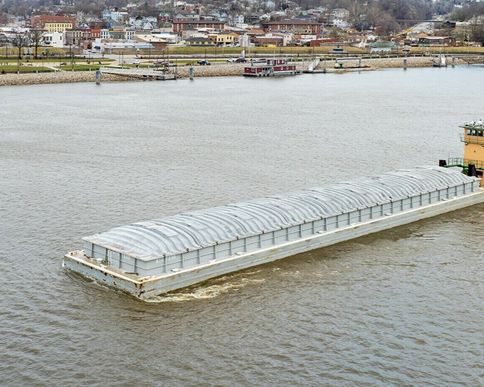 Barges still ply the Mississippi as they did in Twain's day, carrying cargo past Hannibal's shores in a timeless dance of commerce.