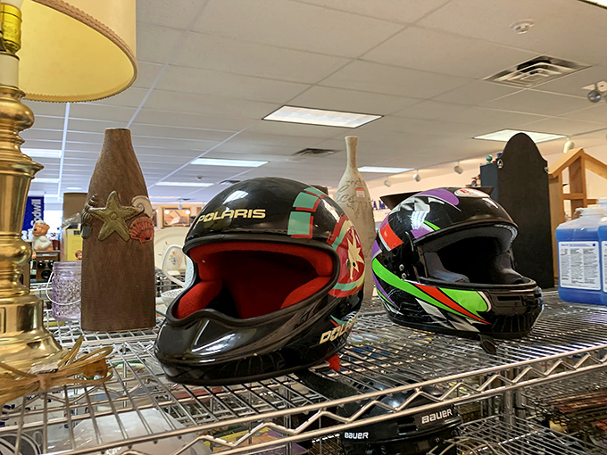 Motorcycle helmets sitting next to decorative vases&mdash;because thrift stores understand that life contains multitudes and unexpected combinations.