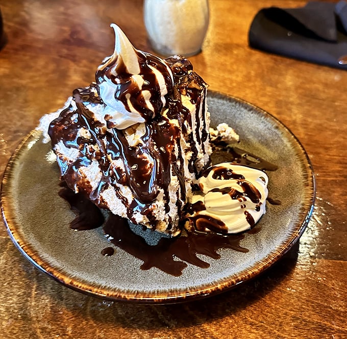 Chocolate, whipped cream, and what appears to be every dessert dream you've ever had, stacked into a slice of pure happiness.