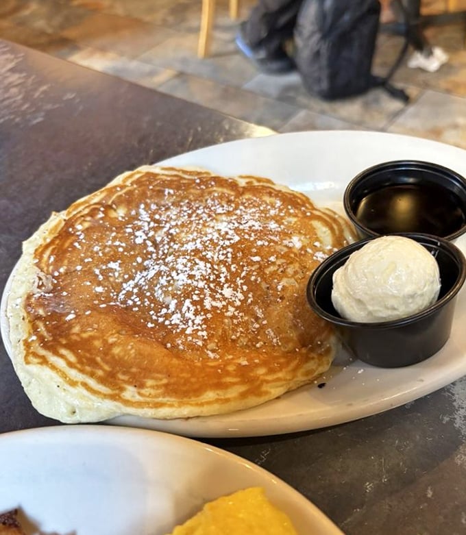 A pancake so perfectly golden it belongs in Fort Knox, served with butter that melts just right. Breakfast simplicity elevated.