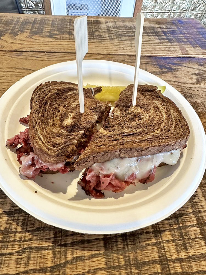 This isn't just a sandwich&mdash;it's what happens when pastrami fulfills its destiny. The melted cheese spilling out is nature's way of saying "you chose correctly."