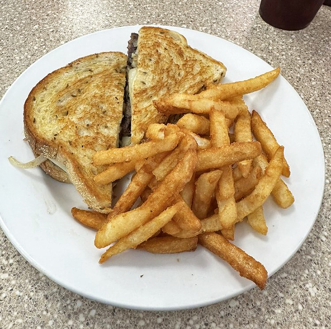 The patty melt and fries&mdash;a dynamic duo that's been solving hunger crises since before superheroes were mainstream. That golden cheese is wearing a cape.
