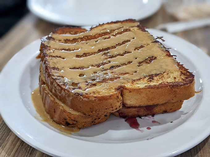 French toast drizzled with what appears to be peanut butter sauce&mdash;breakfast that doubles as comfort food and nostalgia on a plate.