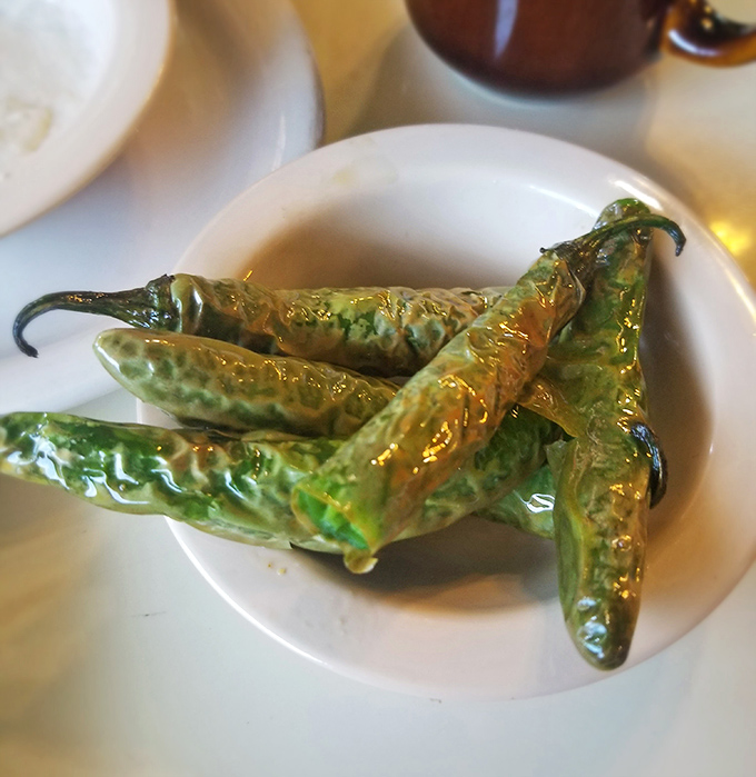These aren't your average garden peppers. Blistered to perfection, they're the side dish that steals the spotlight with their glistening, roasted charm.