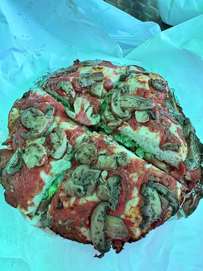 Pizza topped with mushrooms and cheese that stretches like it's auditioning for a cooking show close-up scene.