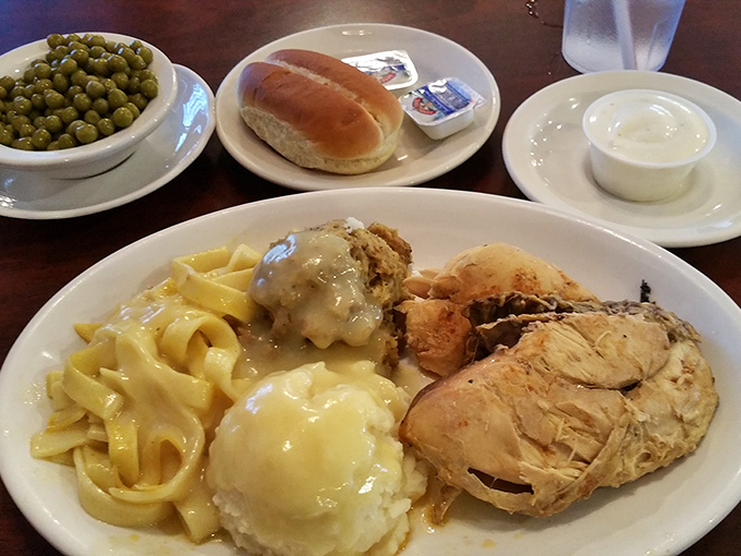 The full dinner experience: tender chicken, homemade noodles, and mashed potatoes with gravy. This isn't a meal; it's a hug on a plate.