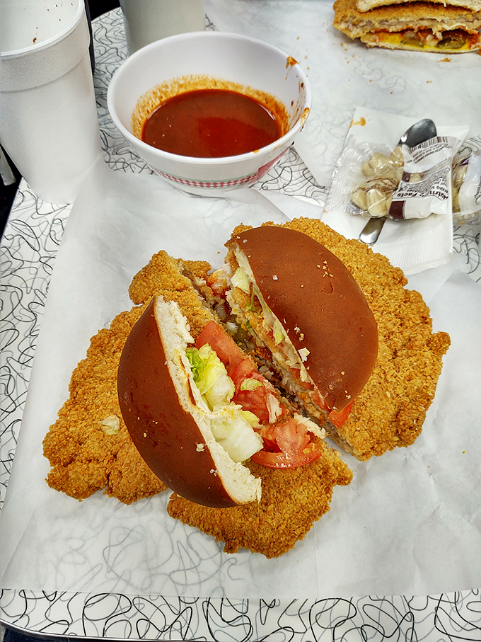 The tenderloin sandwich with all the fixings—where the meat-to-bun ratio makes mathematicians weep and hungry Iowans rejoice.