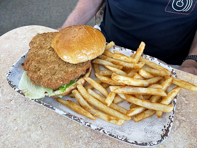 When a sandwich requires its own area code &ndash; this pork tenderloin stretches beyond its bun like the breakfast equivalent of suburban sprawl.