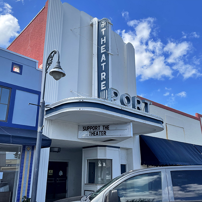 The historic Port Theater's Art Deco facade whispers tales of first dates and Saturday matinees from an era when streaming meant something happening in a creek.