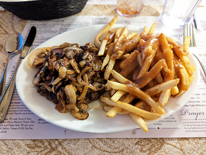 Mushrooms and onions smothered over perfectly seasoned beef, topped with fries that complete this culinary love story.