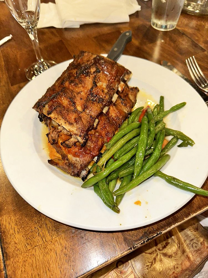 Fall-off-the-bone ribs that make you forget you're in a seafood restaurant. Those green beans aren't just a garnish &ndash; they're absolution for your indulgence.