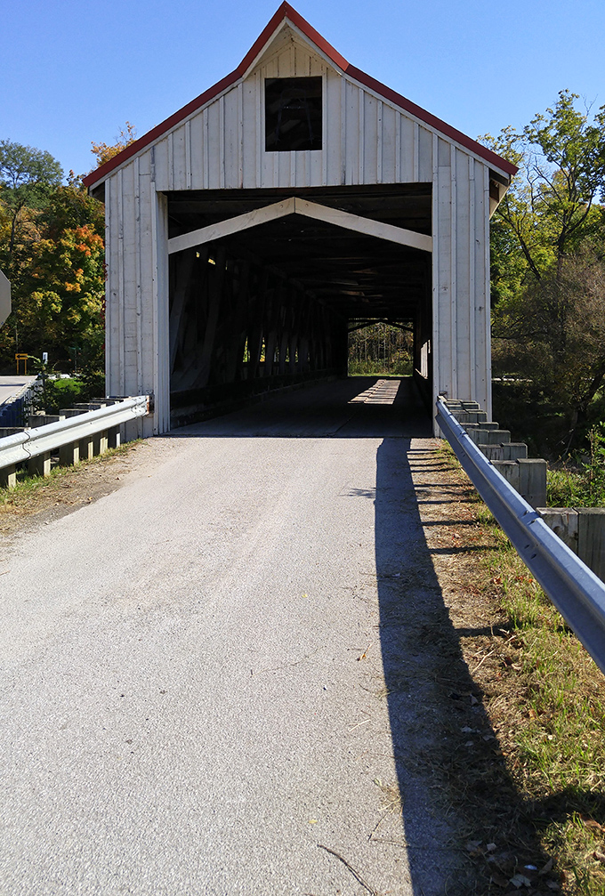 The approach reveals the bridge's welcoming mouth, ready to swallow modern vehicles just as it once embraced horse-drawn carriages and Model Ts.