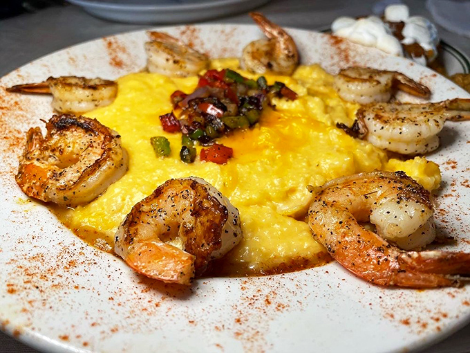 Shrimp and grits elevated to an art form. Those perfectly cooked crustaceans are doing a happy dance on a bed of cheesy sunshine.