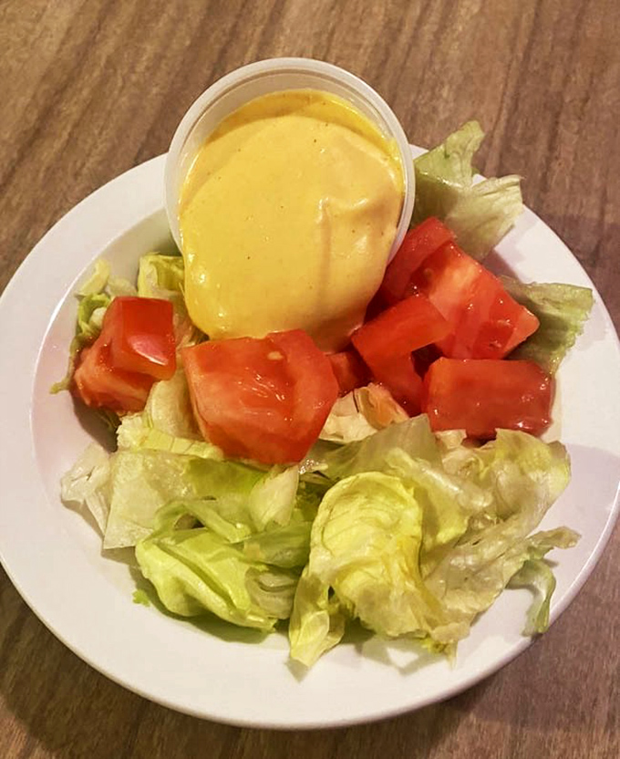 Even the house salad gets respect here&mdash;fresh lettuce, ripe tomatoes, and that signature golden dressing served in an unpretentious plastic cup.