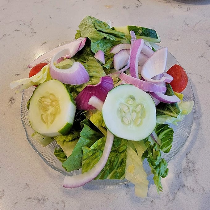 A garden-fresh salad that doesn't feel like punishment. Crisp cucumbers and vibrant red onions proving healthy choices can actually taste like food.