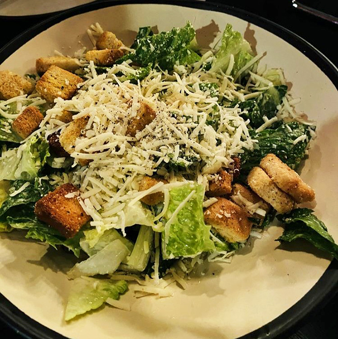 A Caesar salad that actually deserves your attention. Crisp romaine, house-made croutons, and freshly grated cheese create the perfect pizza prelude.