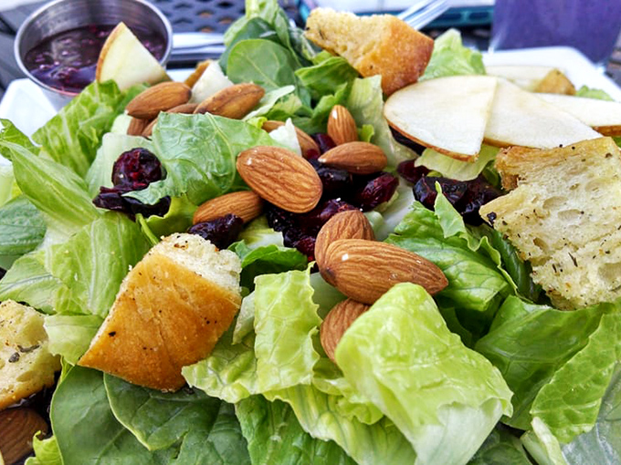 A salad that doesn't apologize for being healthy. Fresh greens, almonds, and cranberries create a symphony of textures worth savoring.