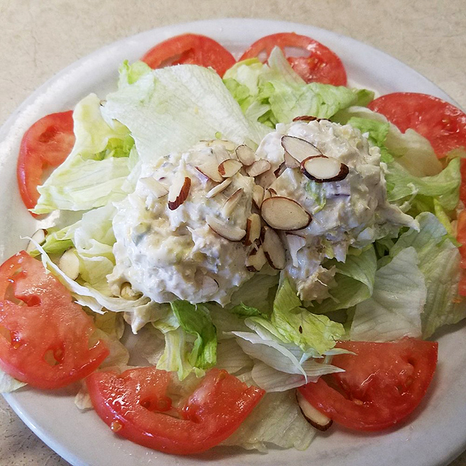 Even the salad gets special treatment here&mdash;a crown of chicken salad atop fresh greens with sliced almonds adding texture that fancy restaurants charge triple for.
