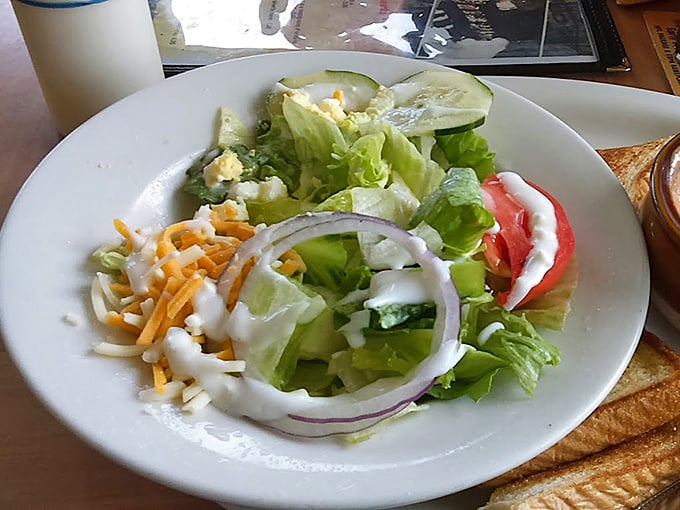 A crisp garden salad stands ready for its supporting role. In the barbecue theater, even the vegetables deserve their moment.