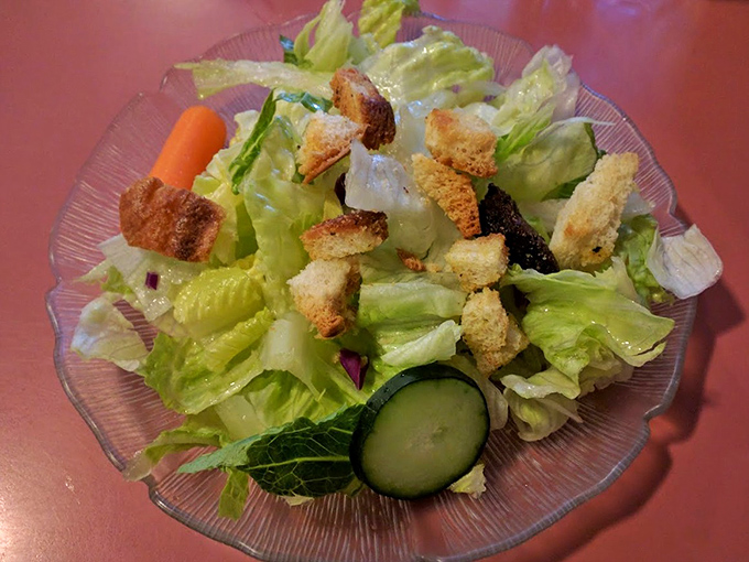 A side salad that knows its role—fresh, crisp, and ready to provide the illusion that you're making healthy choices before demolishing that burger.