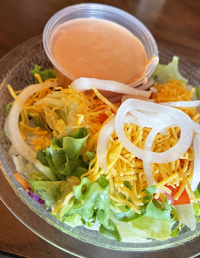 A salad that doesn't apologize for being a salad. That mountain of cheese and homemade dressing transforms lettuce from obligation to celebration.