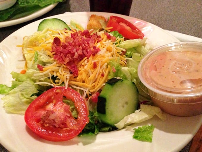 A house salad that didn't get the memo about being a boring side dish. Fresh, colorful, and topped with enough cheese and bacon to make vegetables exciting again.