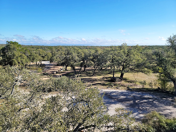 Texas Hill Country stretches to the horizon. The park's elevated vantage points offer breathtaking views that complement the underground experience.