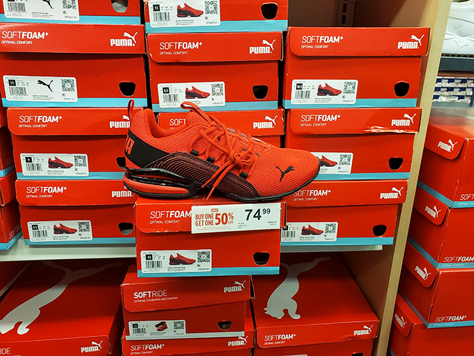 Puma shoes stacked like orange dreams, discounted enough to make you forget you already own twelve pairs at home.