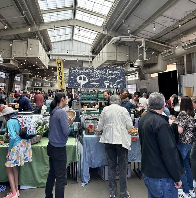 Inside the market pavilion, the serious business of bread selection unfolds&mdash;a carbohydrate cathedral where devotees worship at the altar of artisanal baking.