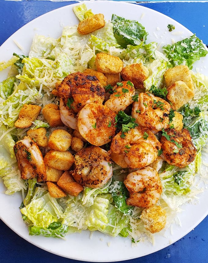 Plump, blackened shrimp lounging on a Caesar salad like they own the place – which, at Crabby Bill's, they absolutely do.