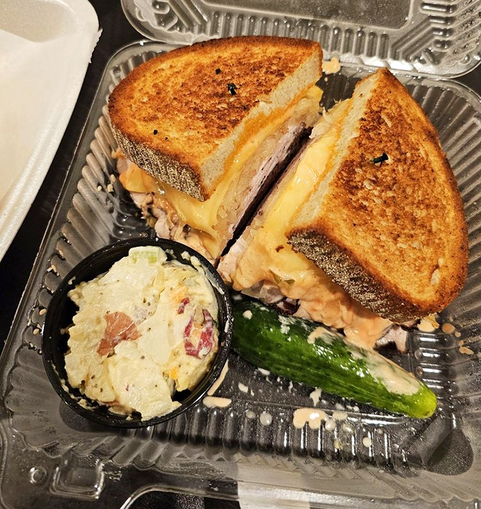 The smoked turkey Reuben comes with its own tiny flags, as if claiming territory in the republic of ridiculous sandwich proportions.