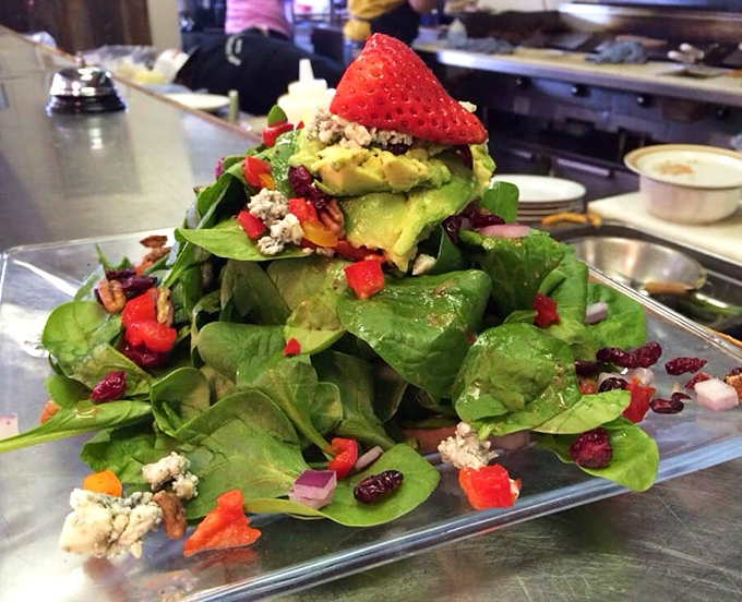 This towering spinach salad with strawberries and avocado makes eating your greens feel less like punishment, more like paradise.