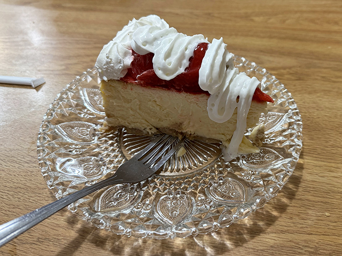 A slice of strawberry cheesecake on a crystal plate&mdash;because sometimes the simplest pleasures deserve the fanciest presentation.