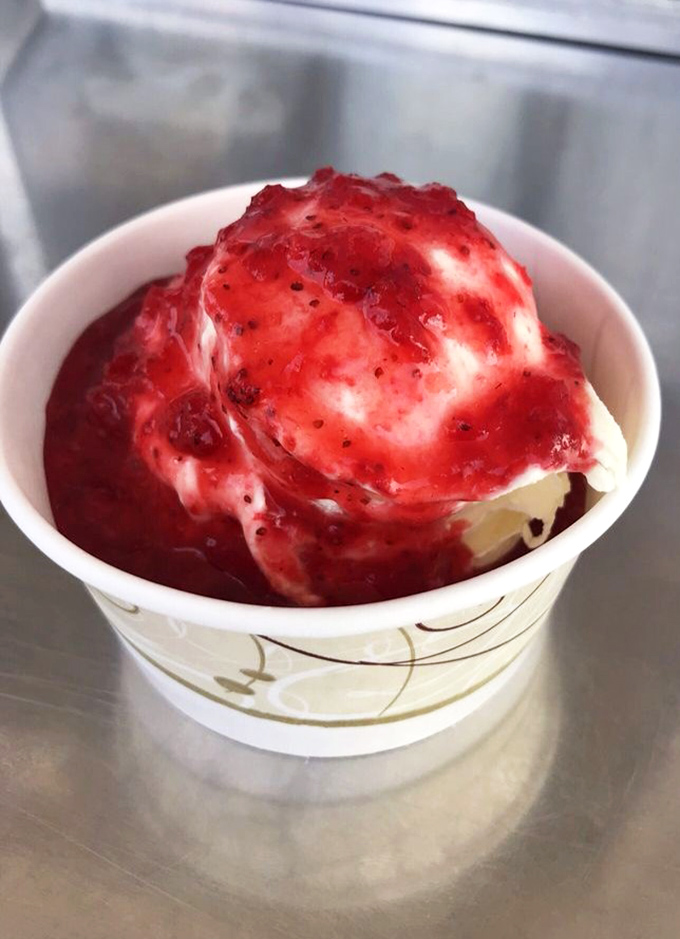 Strawberry sauce cascading over vanilla custard like a berry waterfall. Nature's candy meeting dairy perfection in a cup of pure summer joy.