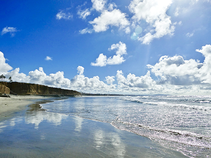 Heaven reflected &ndash; where Terramar's wet sand mirrors perfect clouds, creating twice the beauty in a single glance.
