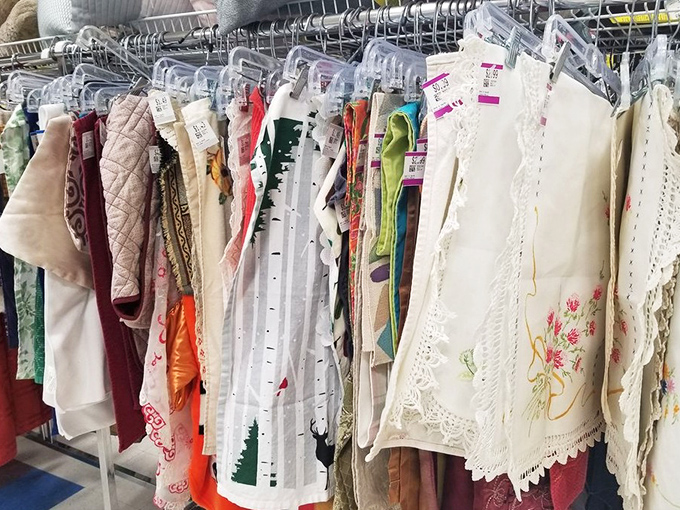 Delicate linens and table runners showcase intricate needlework from hands unknown. Someone's grandmother's pride now awaits a new dining room table.