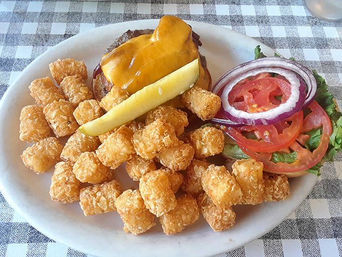Golden tater tots surrounding a cheeseburger—proof that sometimes the supporting actors steal the show.
