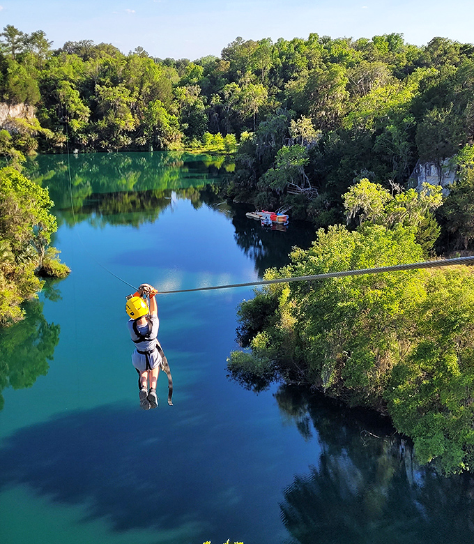 Adventure seekers zip across emerald waters at The Canyons, where Florida's limestone quarries have transformed into an unexpected playground for the brave.