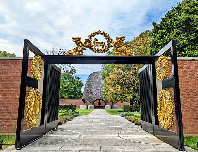 The Roofless Church's golden gates stand like heaven's front door, leading to Philip Johnson's modernist sanctuary where sky becomes ceiling.