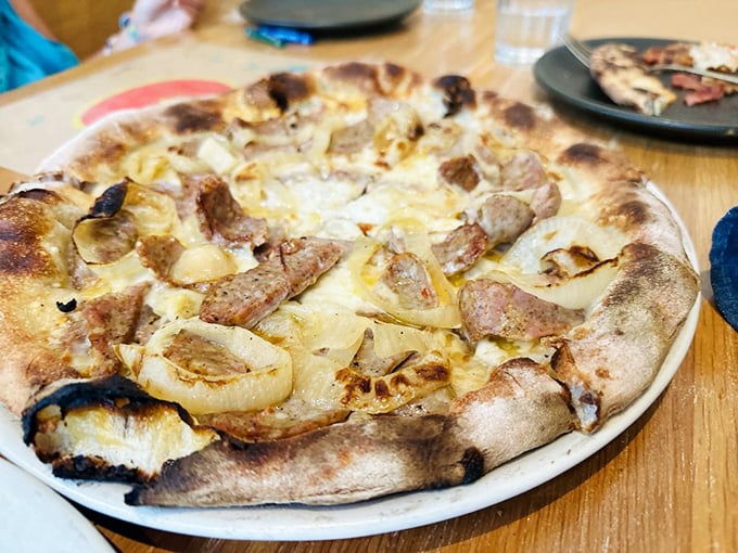 The Wiseguy Pizza flaunts wood-roasted onions and fennel sausage with the confidence of someone who knows they're about to change your definition of delicious.