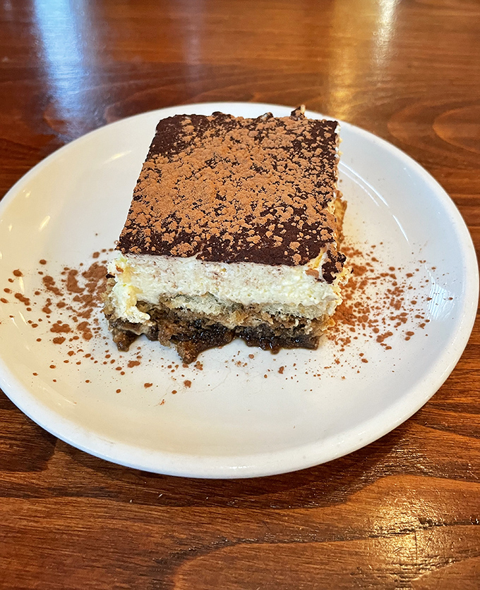 Tiramisu that transports you straight to an Italian caf&eacute; &ndash; layers of coffee-soaked ladyfingers and mascarpone dusted with cocoa like a sweet Tuscan landscape.