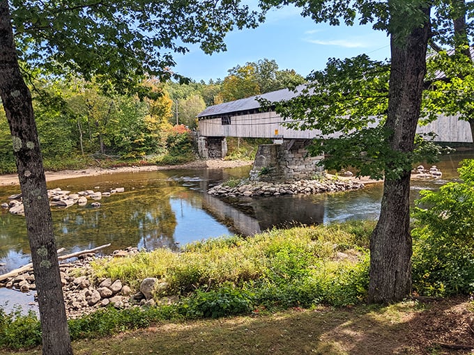 Framed by nature's perfect composition, the bridge reflects in tranquil waters while autumn paints the surrounding landscape.